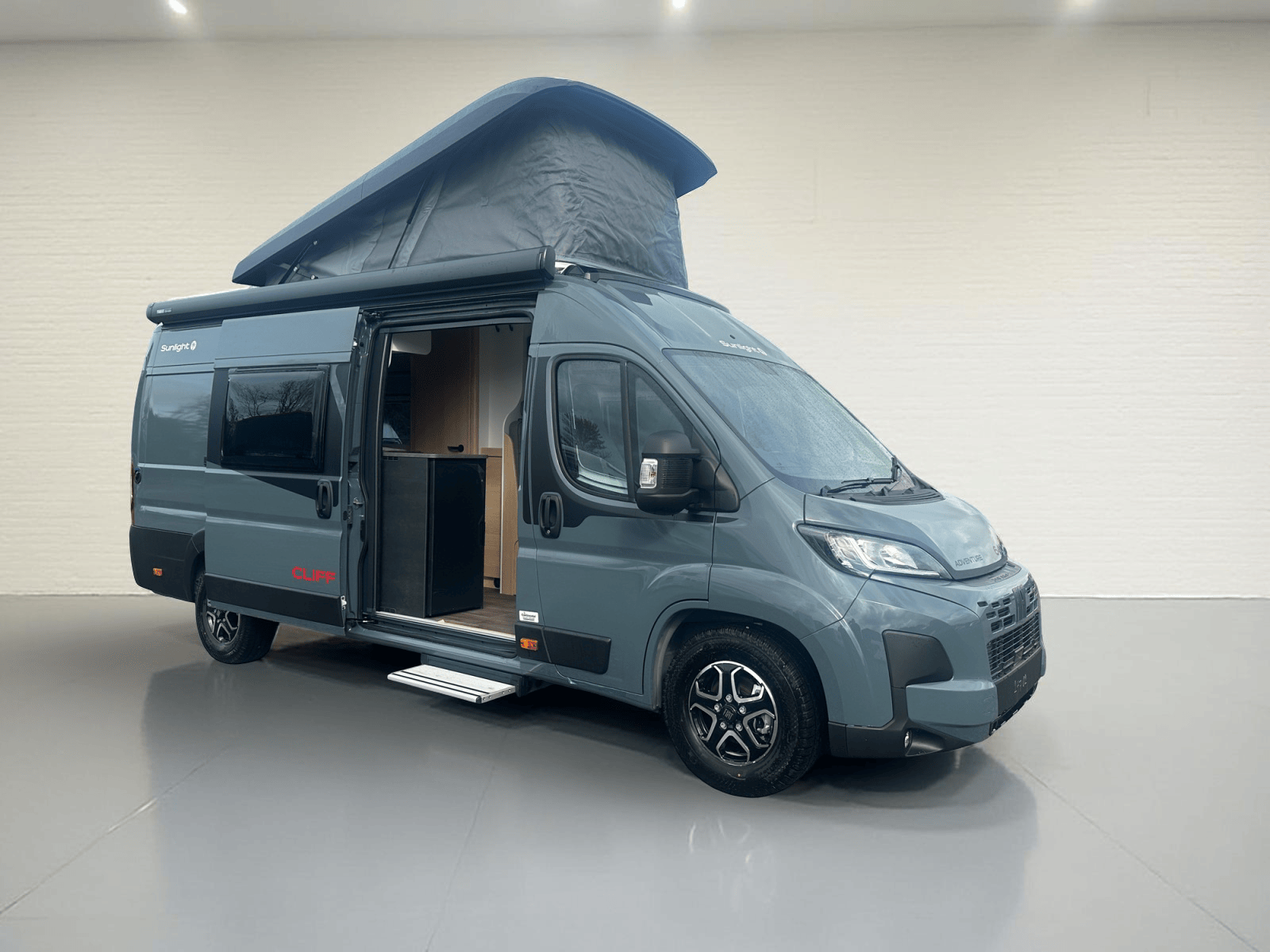 Sunlight cliff 640RT with pop top open in showroom